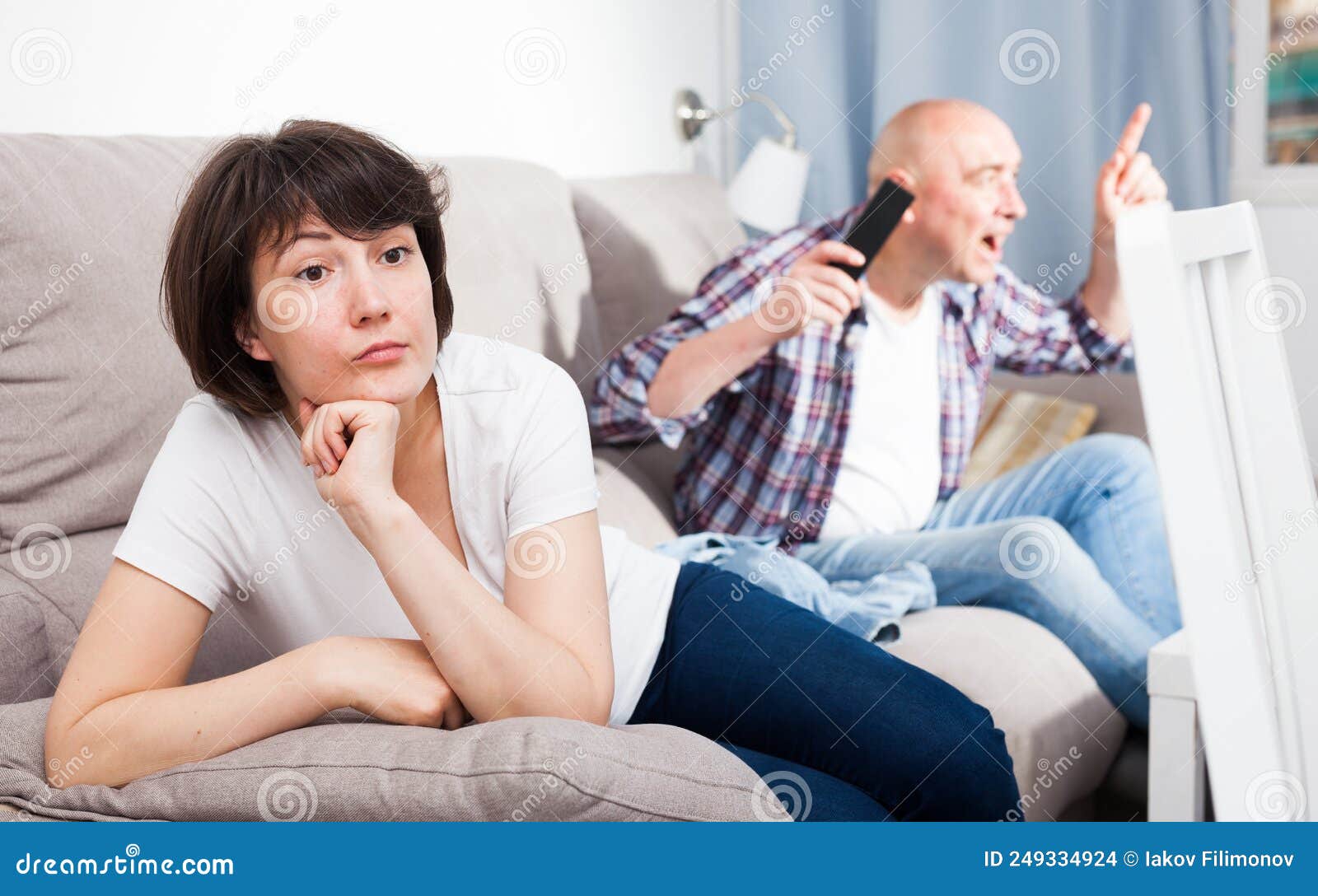 Upset Mature Woman After Quarrel With Husband At Home Interior Stock