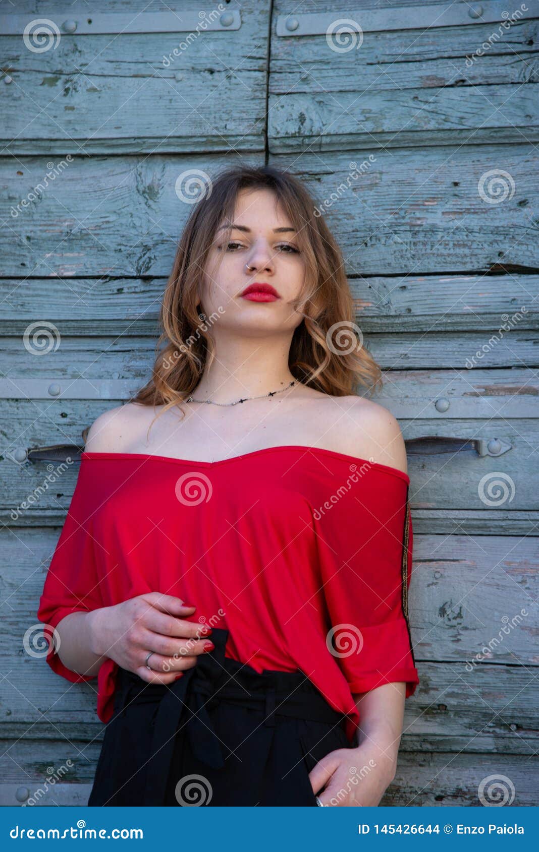 Portrait Of A Very Sensual Blonde Girl He Is Wearing A Red Shirt That