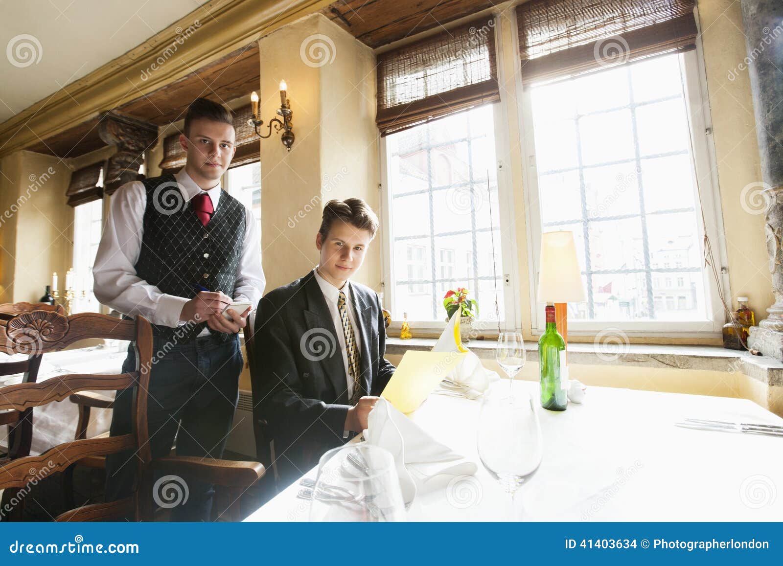 Portrait of Waiter and Businessman at Restaurant Table Stock Photo ...