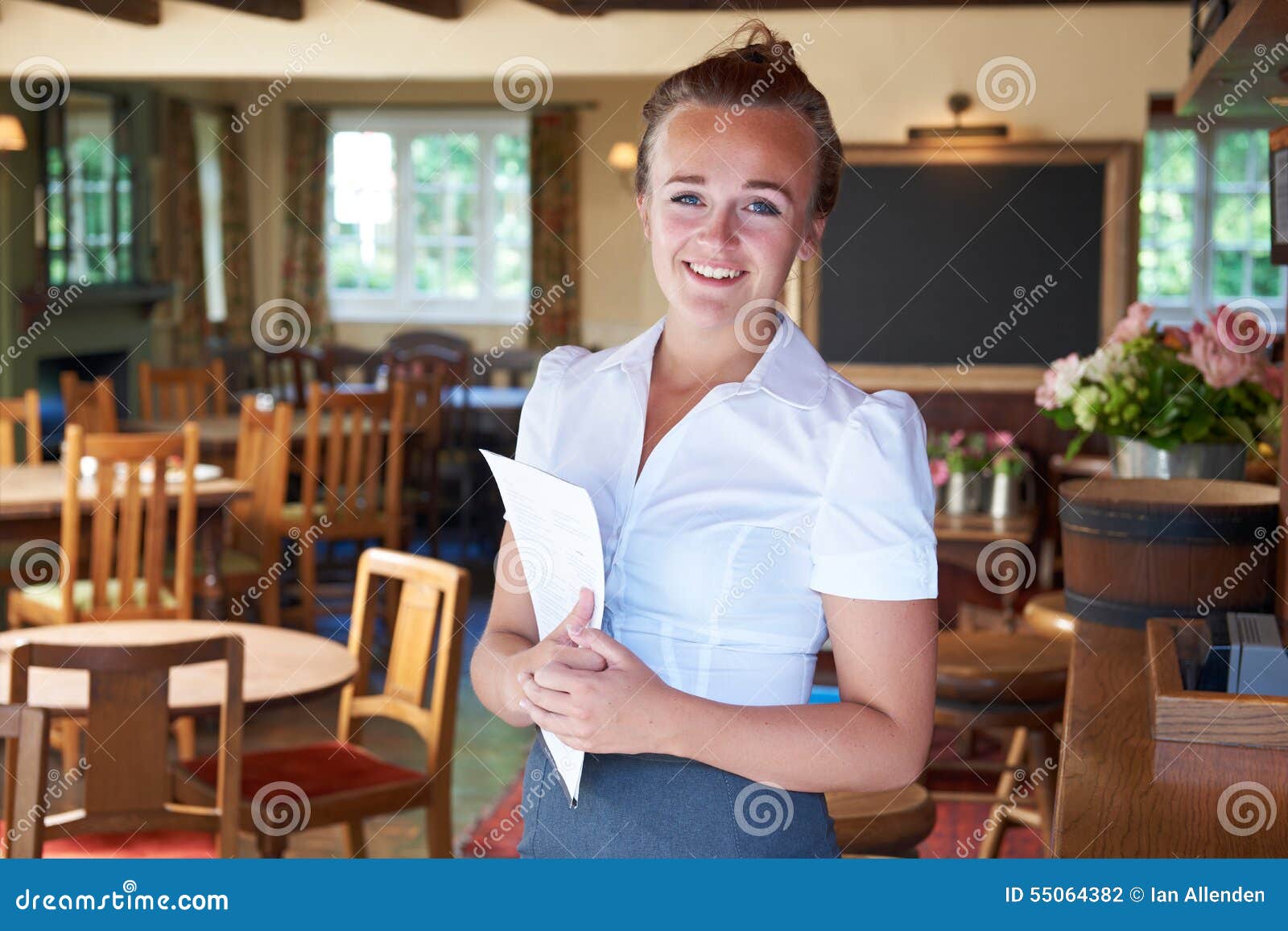 Portrait of Waitress Holding Menu in Restaurant Stock Photo - Image of ...