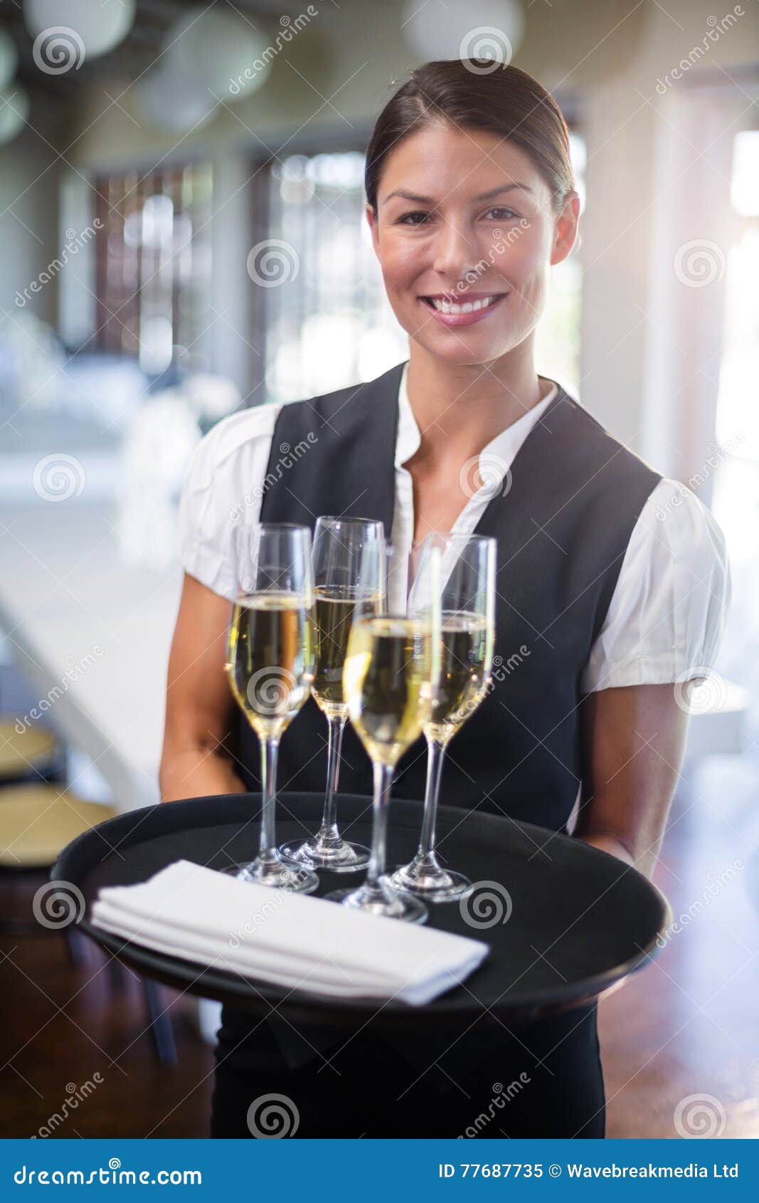 Portrait Of Waitress Holding Serving Tray With Champagne Flutes Stock