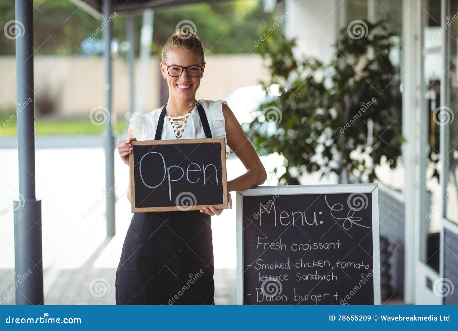 Portrait of Waitress Standing with Chalkboard and Menu Stock Image ...