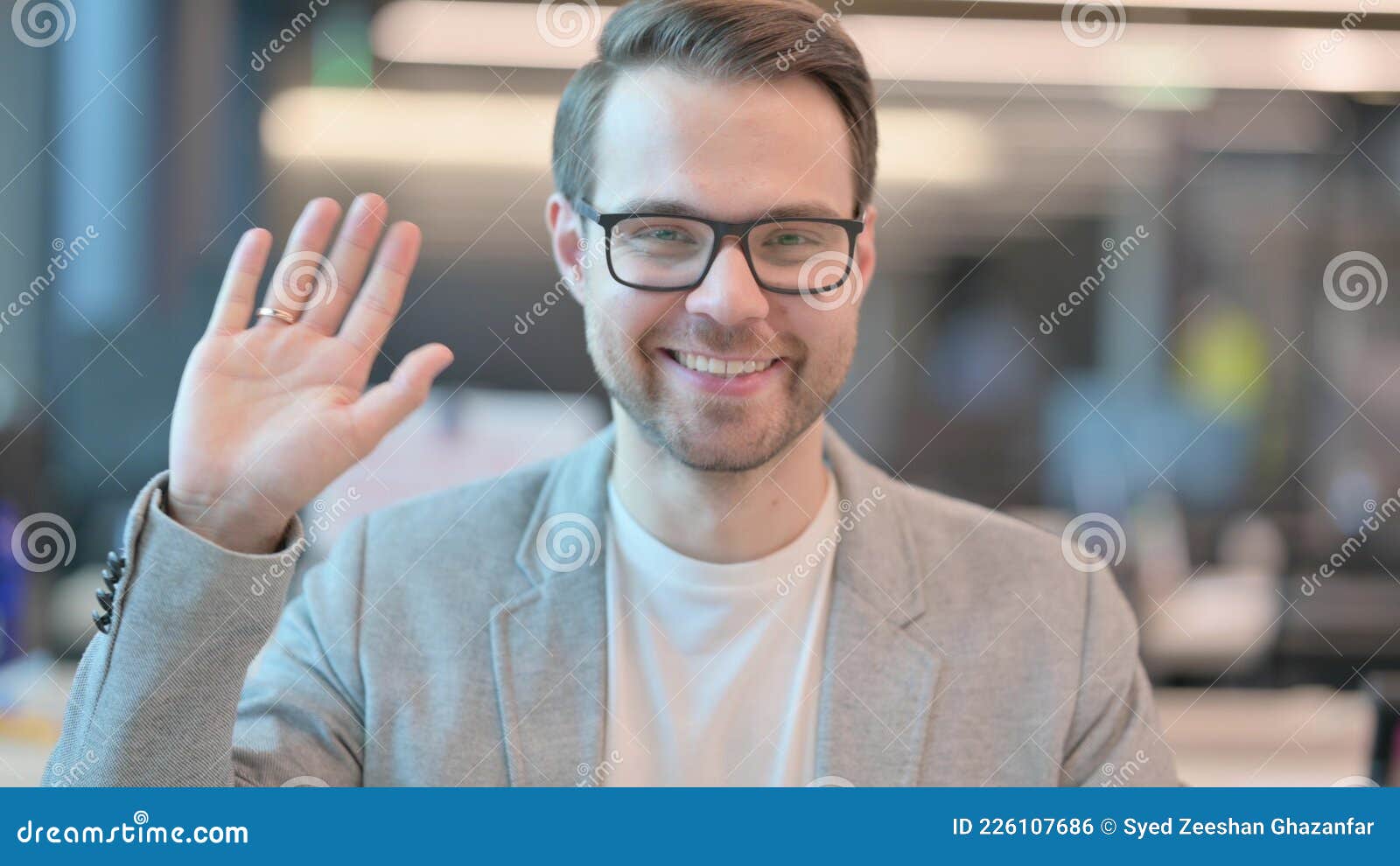 Portrait of Welcoming Young Man Waving for Hello Stock Photo - Image of ...