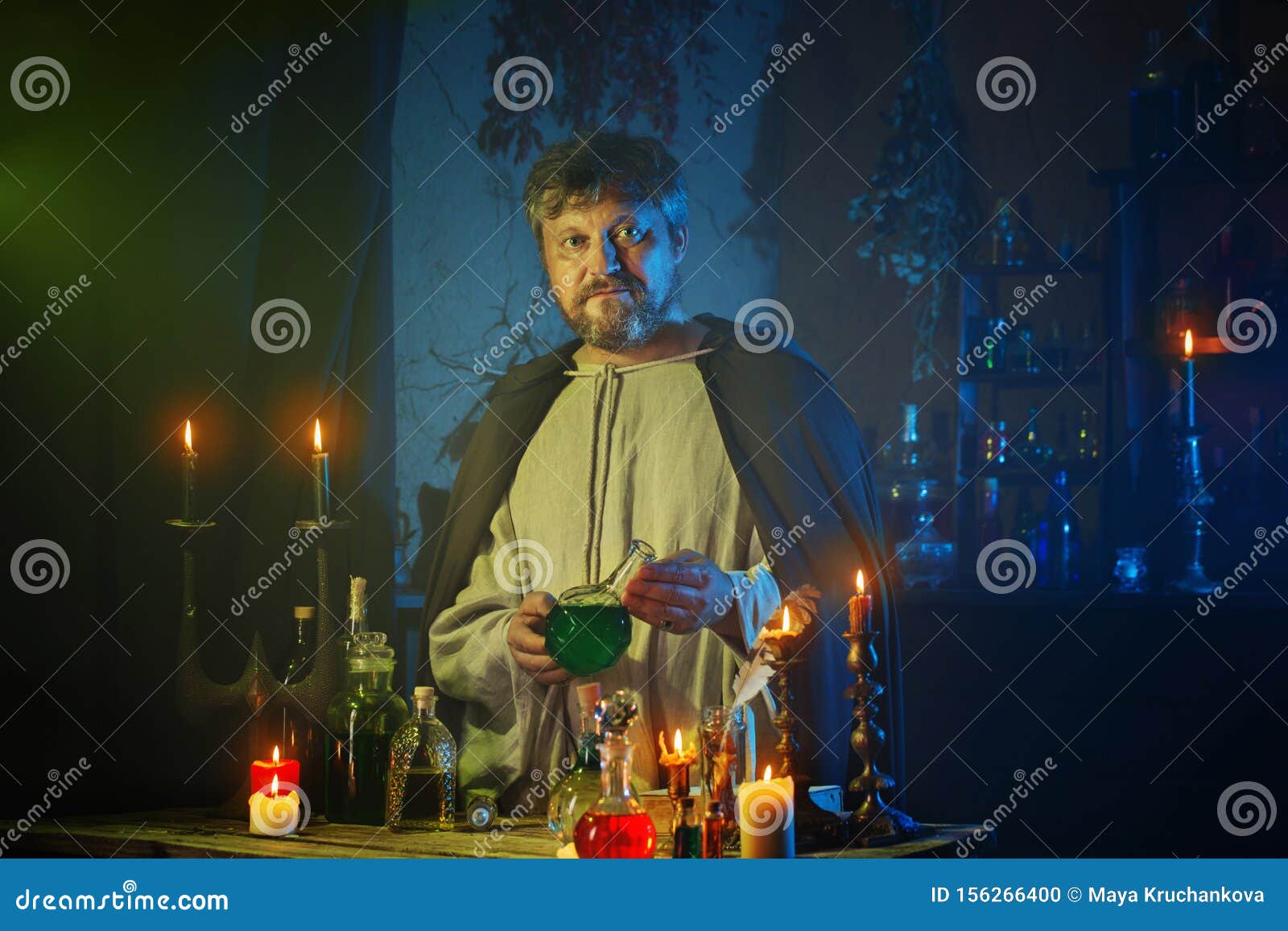 Wizard with Burning Candles and Magic Potions Stock Photo - Image of ...