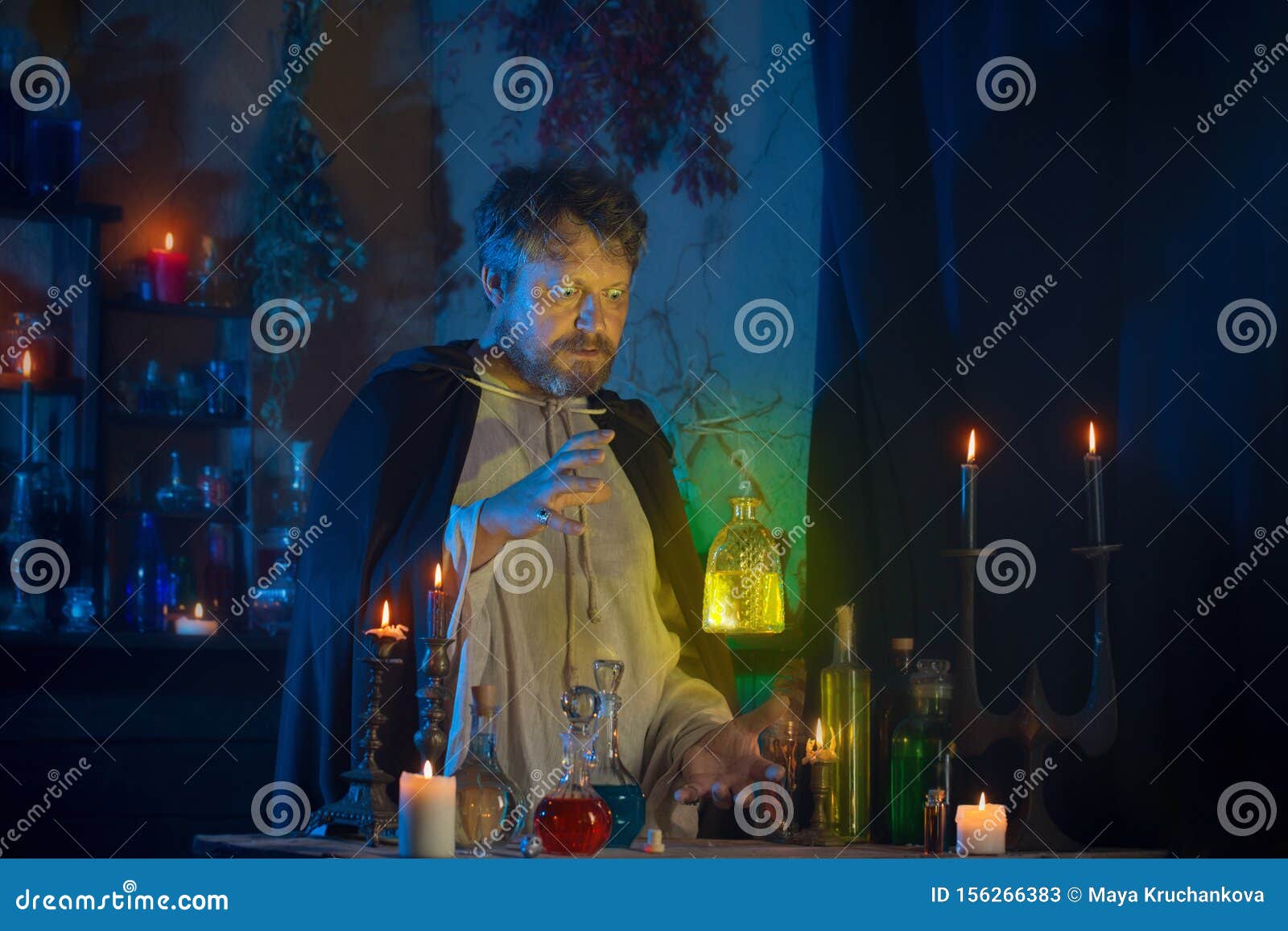 Portrait of Wizard with Burning Candles and Magic Potions Stock Image ...