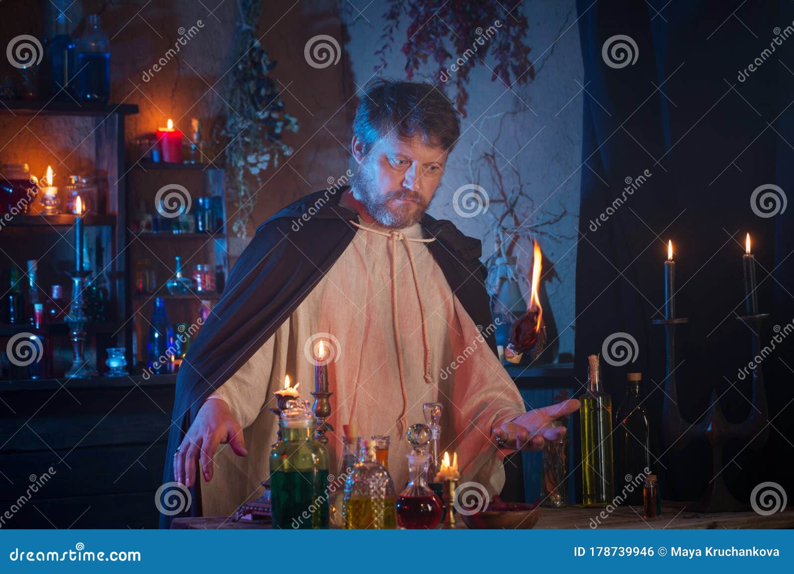 Wizard with Burning Candles and Magic Potions Stock Photo - Image of ...
