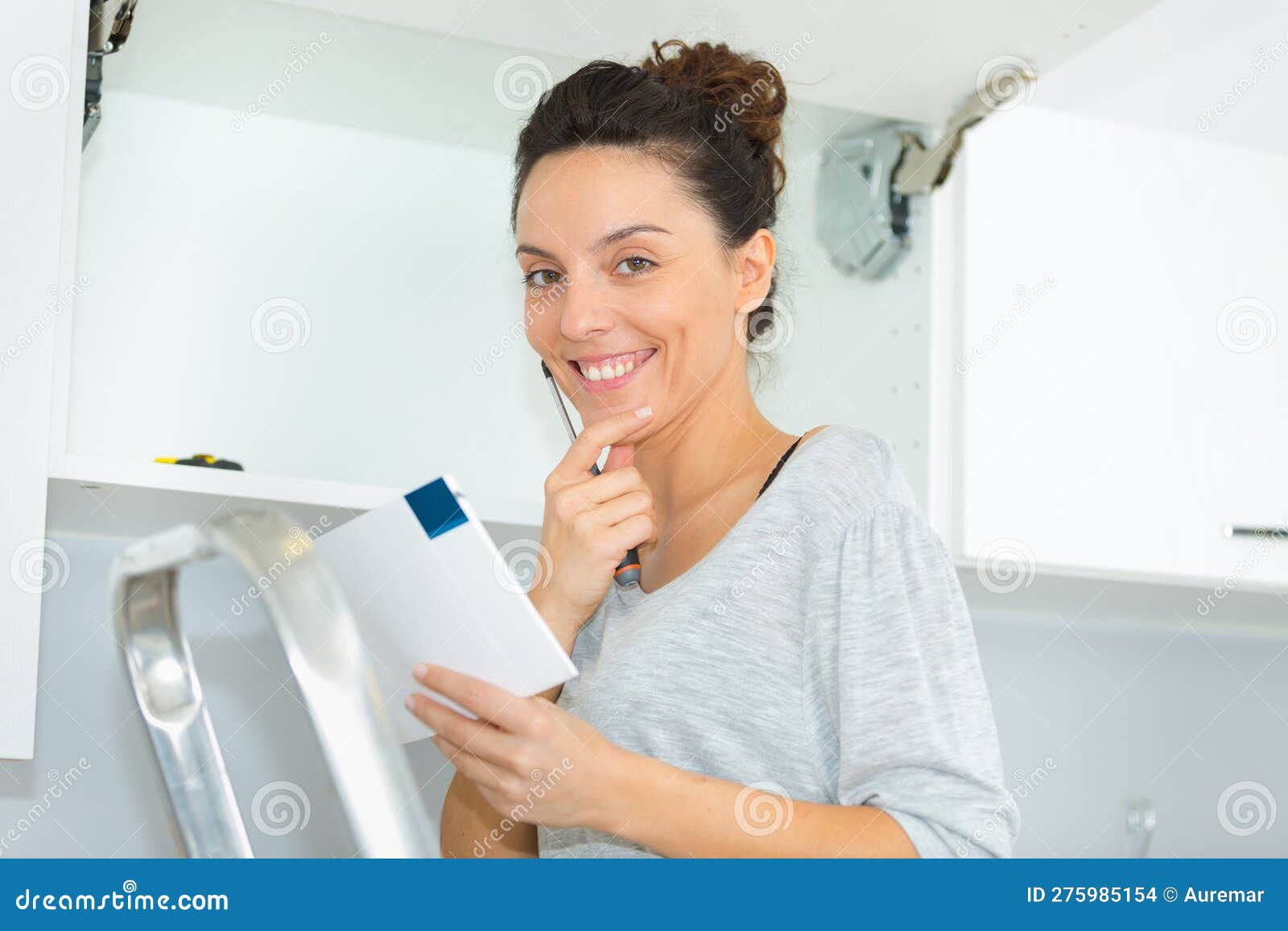 Portrait Woman Installing Kitchen Cupboard Stock Photo - Image of flat ...