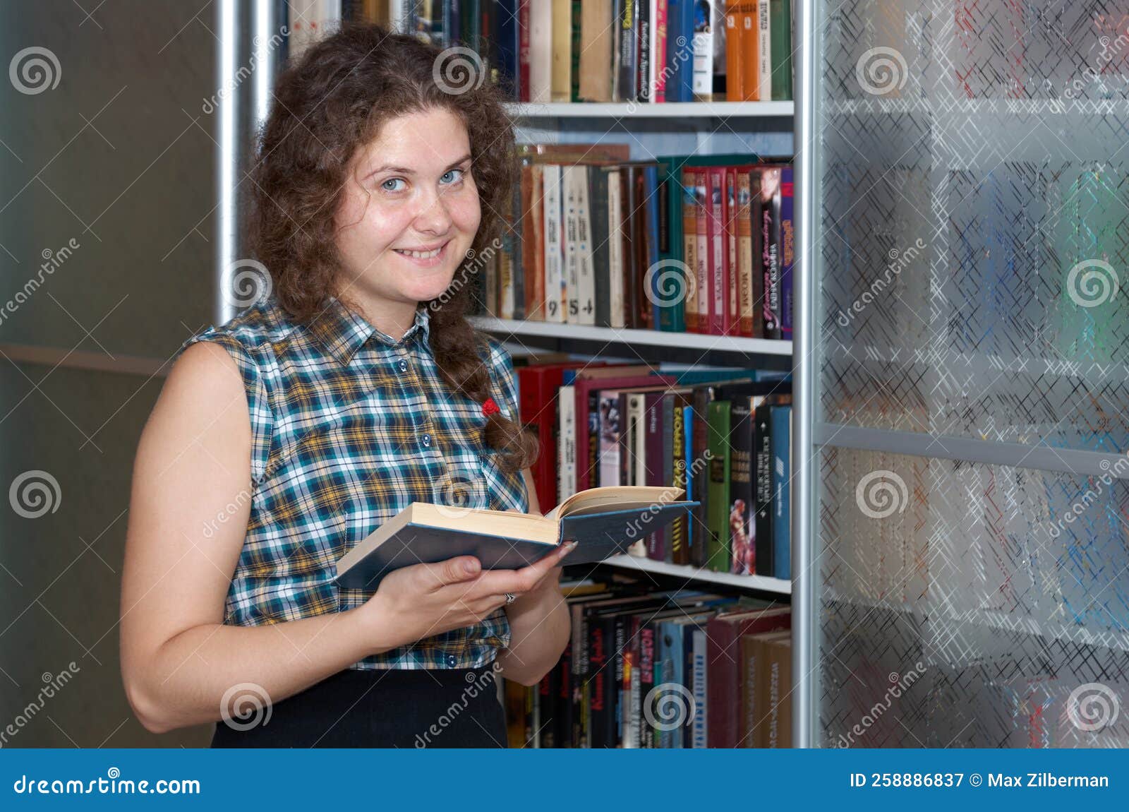Portrait of Woman Reading a Book in Front of a Bookcase Stock Image ...