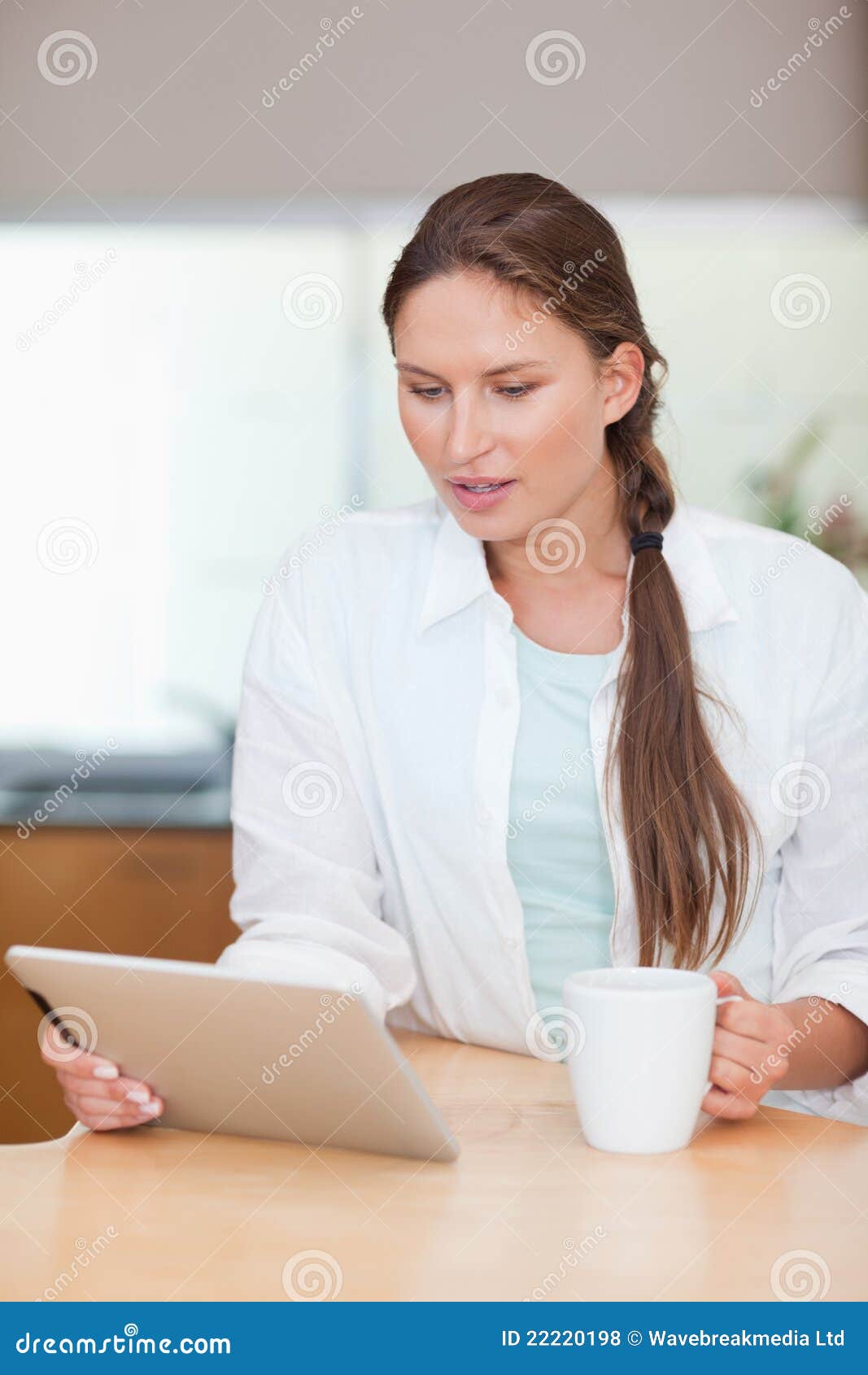 Portrait of a Woman Using a Tablet Computer while Drinking Tea Stock ...