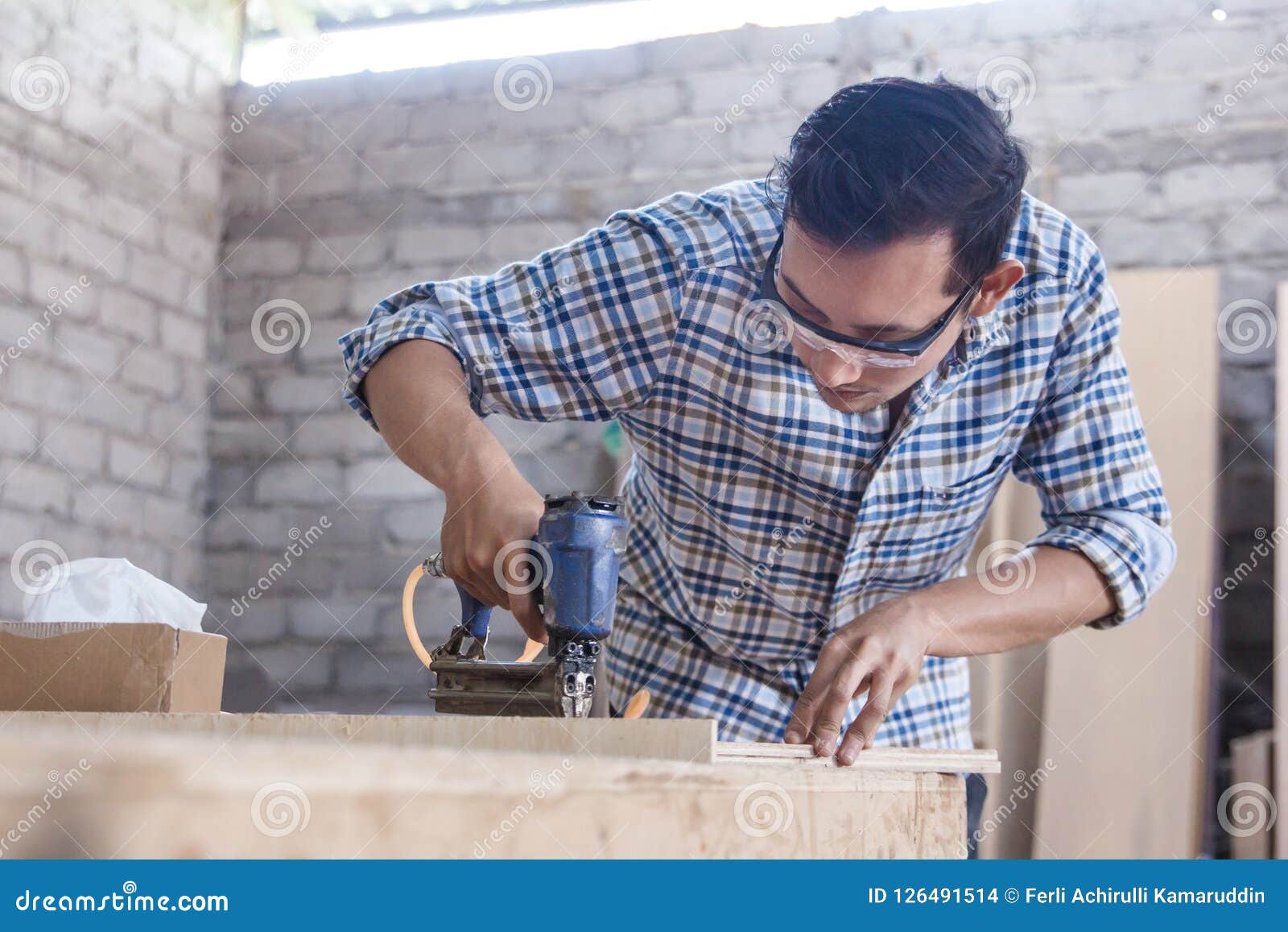 Worker at Carpenter Workspace Installing Nail Using Pneumatic Na Stock ...