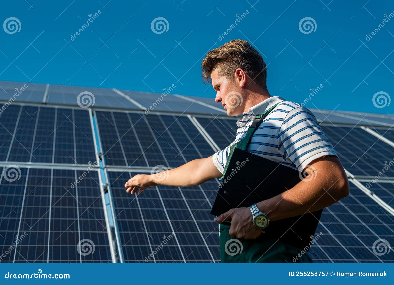 Portrait of Worker in Protective Uniform Standing Near Solar Panels ...