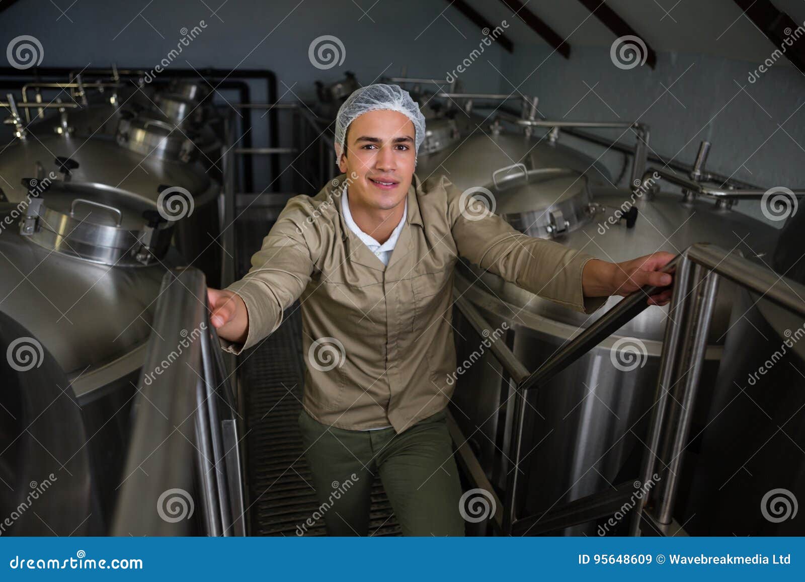 Portrait of Worker Standing Amidst Storage Tanks on Steps Stock Image ...