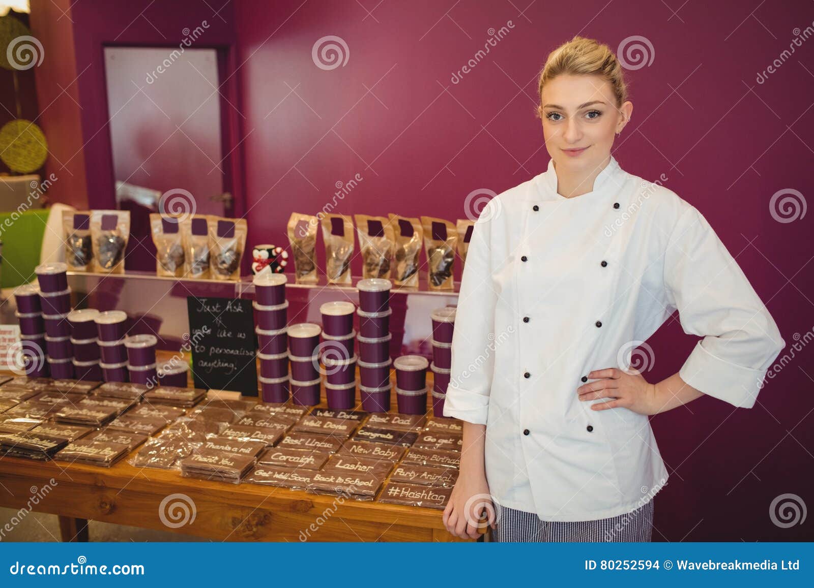 Portrait of Worker Standing Next To Chocolate Display Stock Photo ...