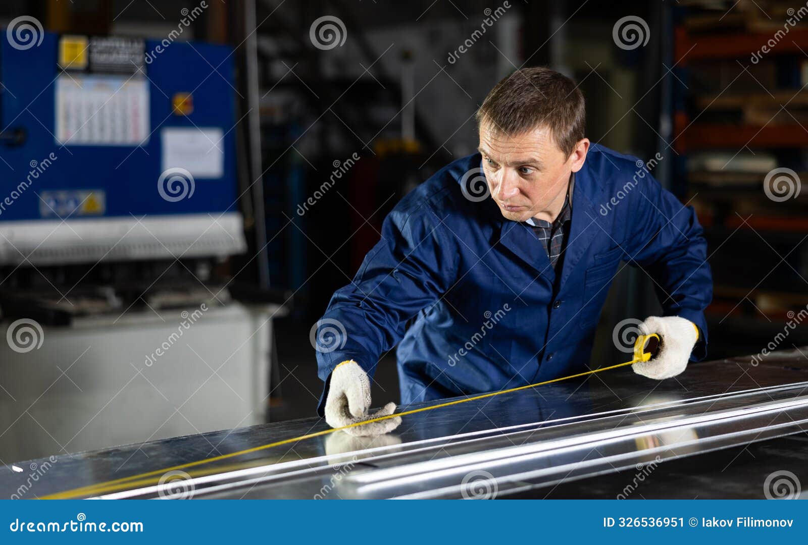 Portrait of Worker with Tape Measure Who Measures Sheet of Iron Using ...