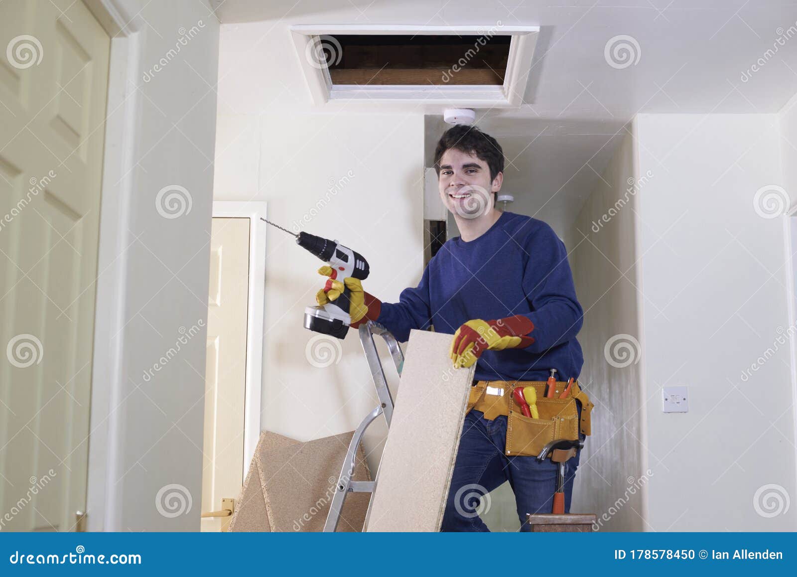 Portrait of Workman Fitting Boards To Floor of House Loft Stock Photo ...