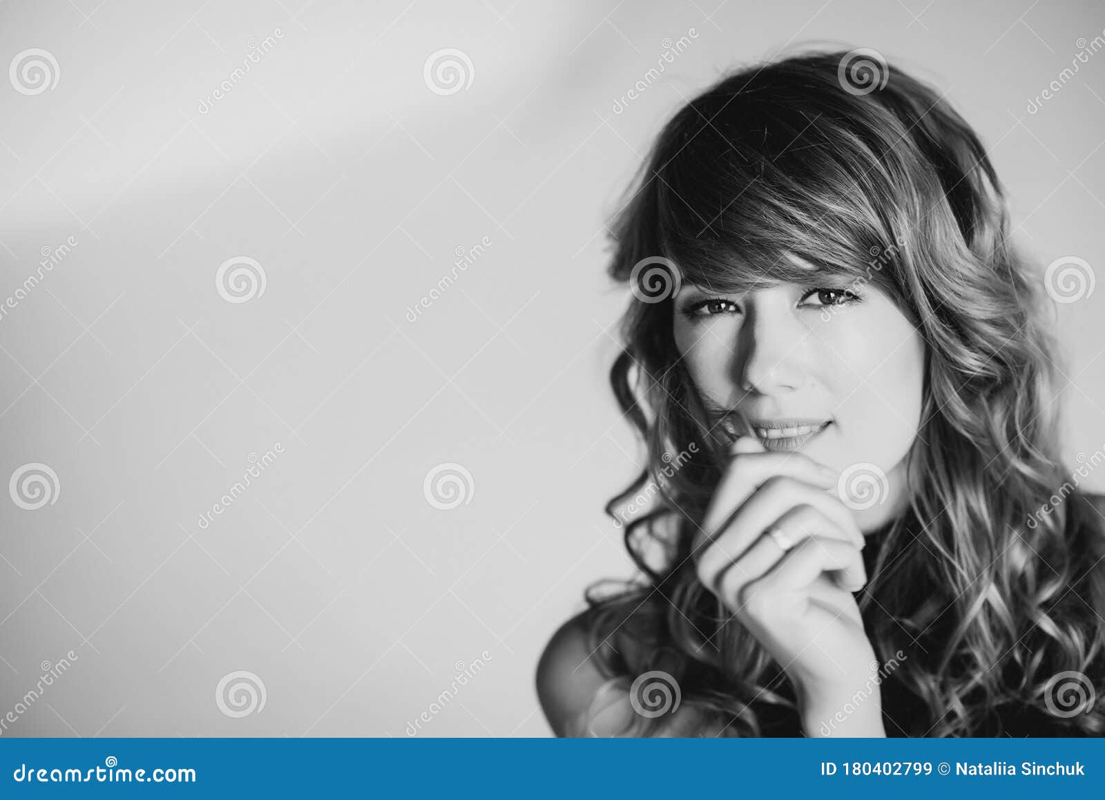 Portrait Of A 36 Year Old Woman With Curly Hair And Brown Slanting Eyes