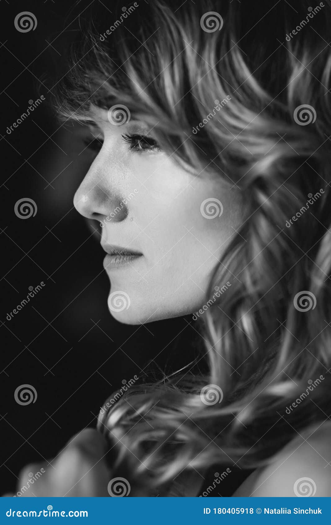 Portrait Of A 36 Year Old Woman With Curly Hair And Brown Slanting Eyes