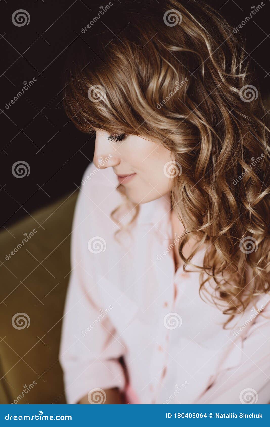 Portrait Of A 36 Years Old Woman With Curly Hair And Brown Slanting