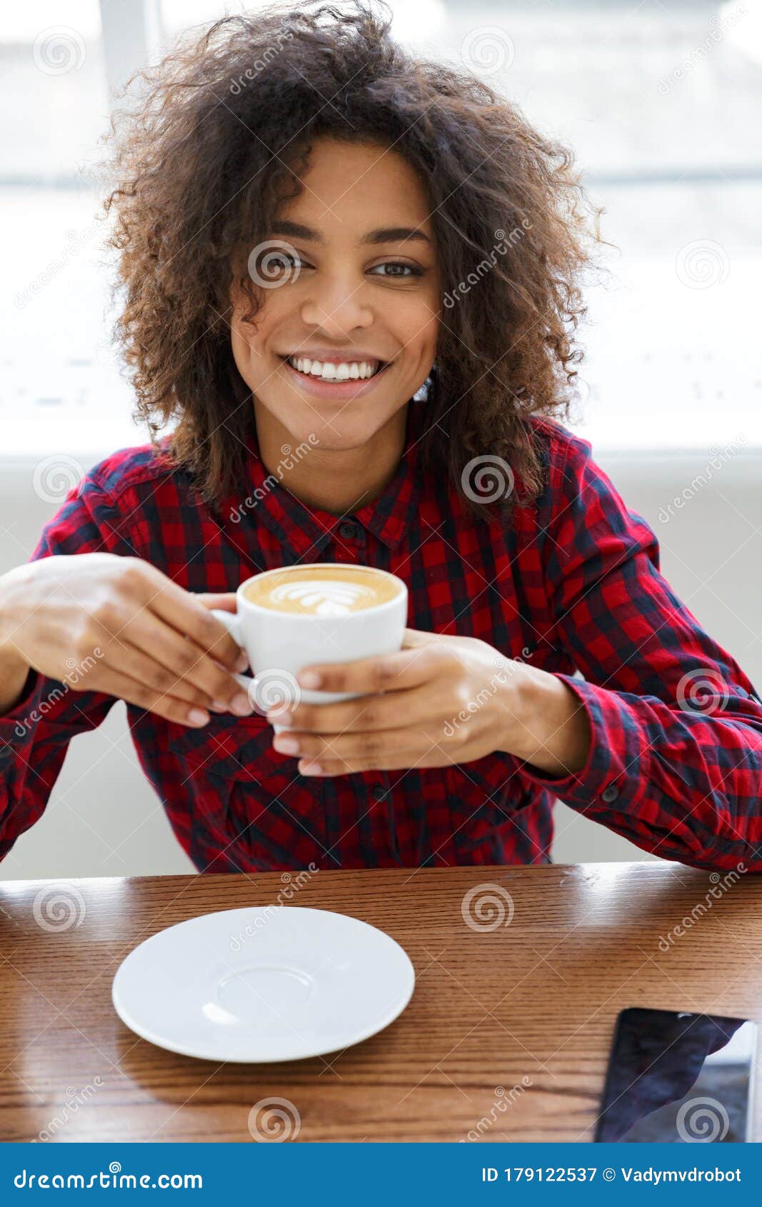Portrait Of Young African American Woman Drinking Coffee In Cafe Stock