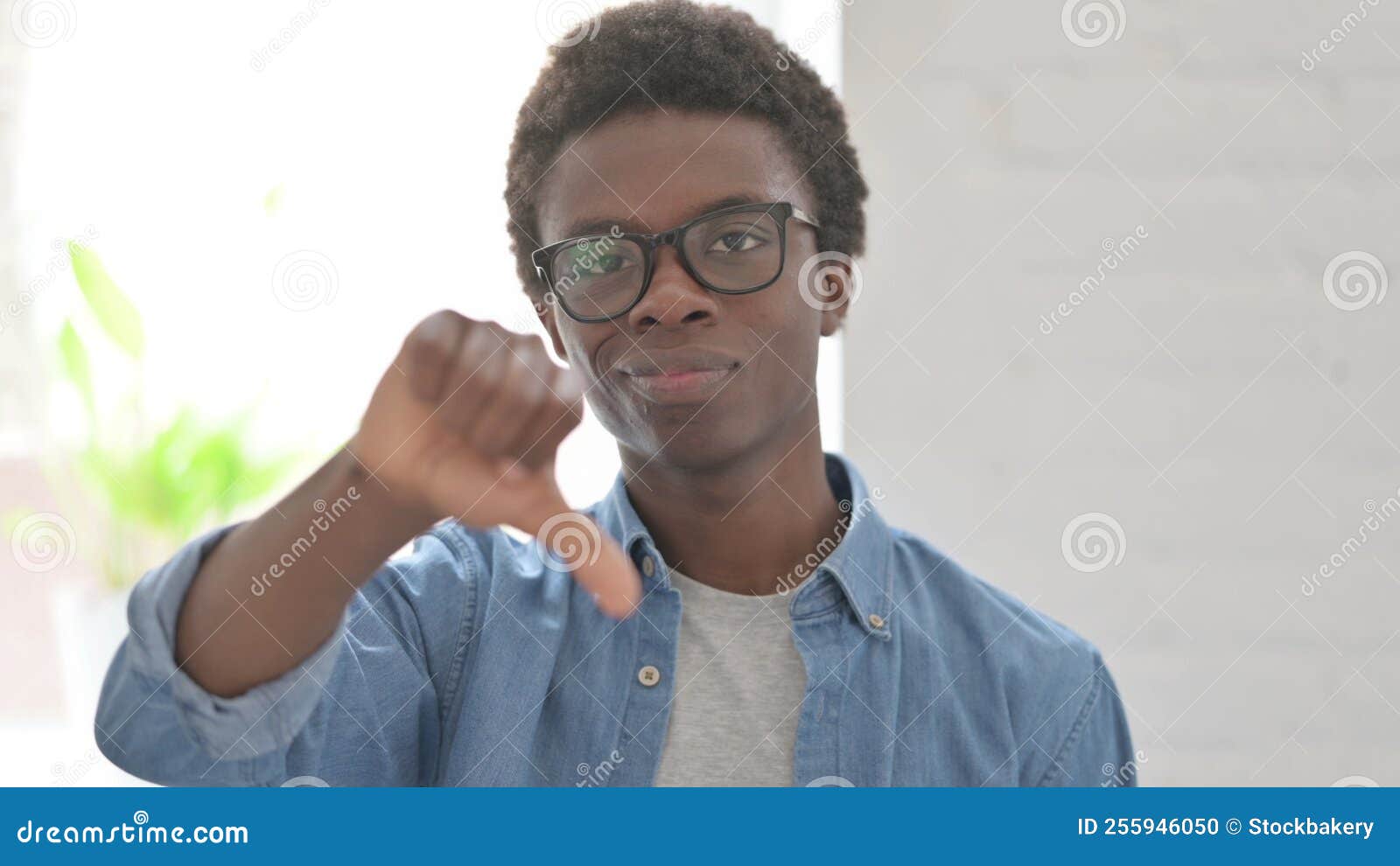 Portrait of Young African Man Showing Thumbs Down Stock Photo - Image ...