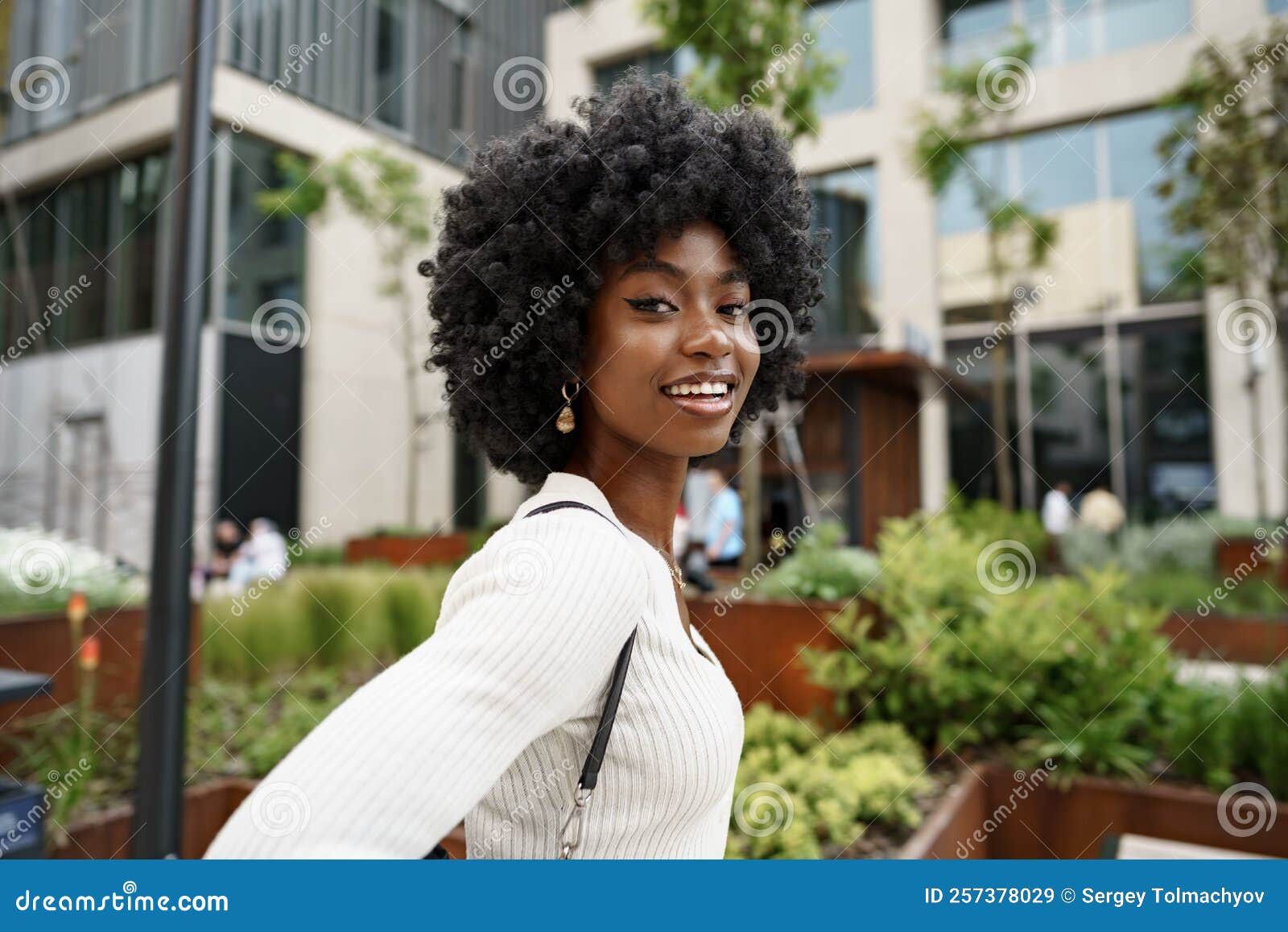 Portrait Of Young African Woman With Afro Hairstyle Smiling In Urban
