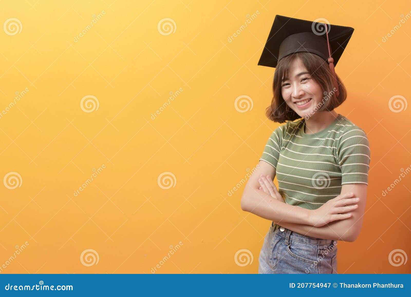 Portrait of Young Asian Student Wearing Graduation Cap Over Studio ...