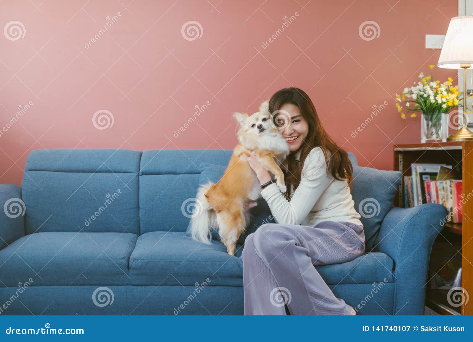 Portrait of Young Asian Woman Holding Her Dog Chihuahua on Sofa at Home ... Portrait of Young Asian Woman Holding Her Dog Chihuahua on Sofa at Home ...