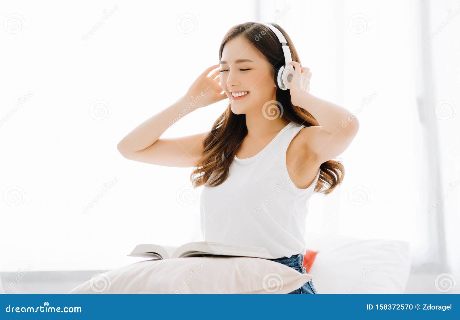 Portrait Of Young Asian Woman Smiling Friendly Listening Music In