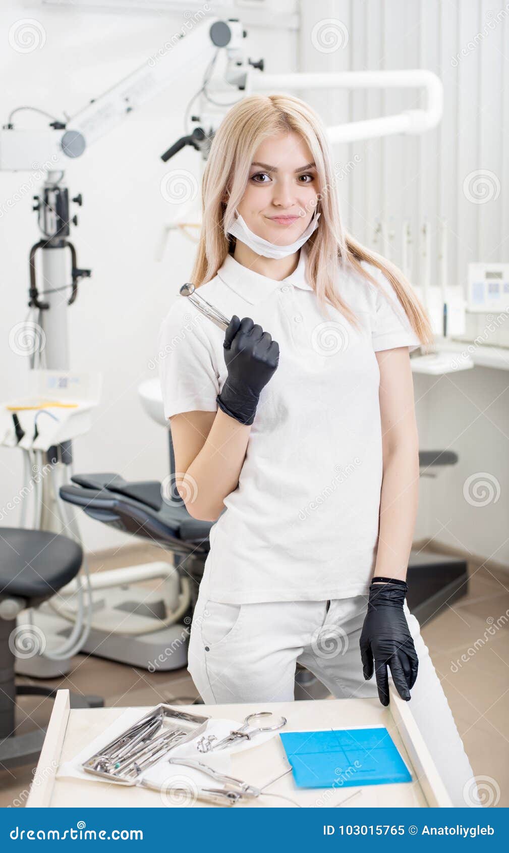 Portrait Of Young Attractive Female Dentist Holding Dental Tool At The