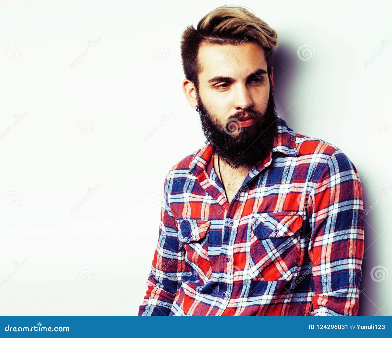 Portrait Of Young Bearded Hipster Guy Smiling On Gray Background Stock