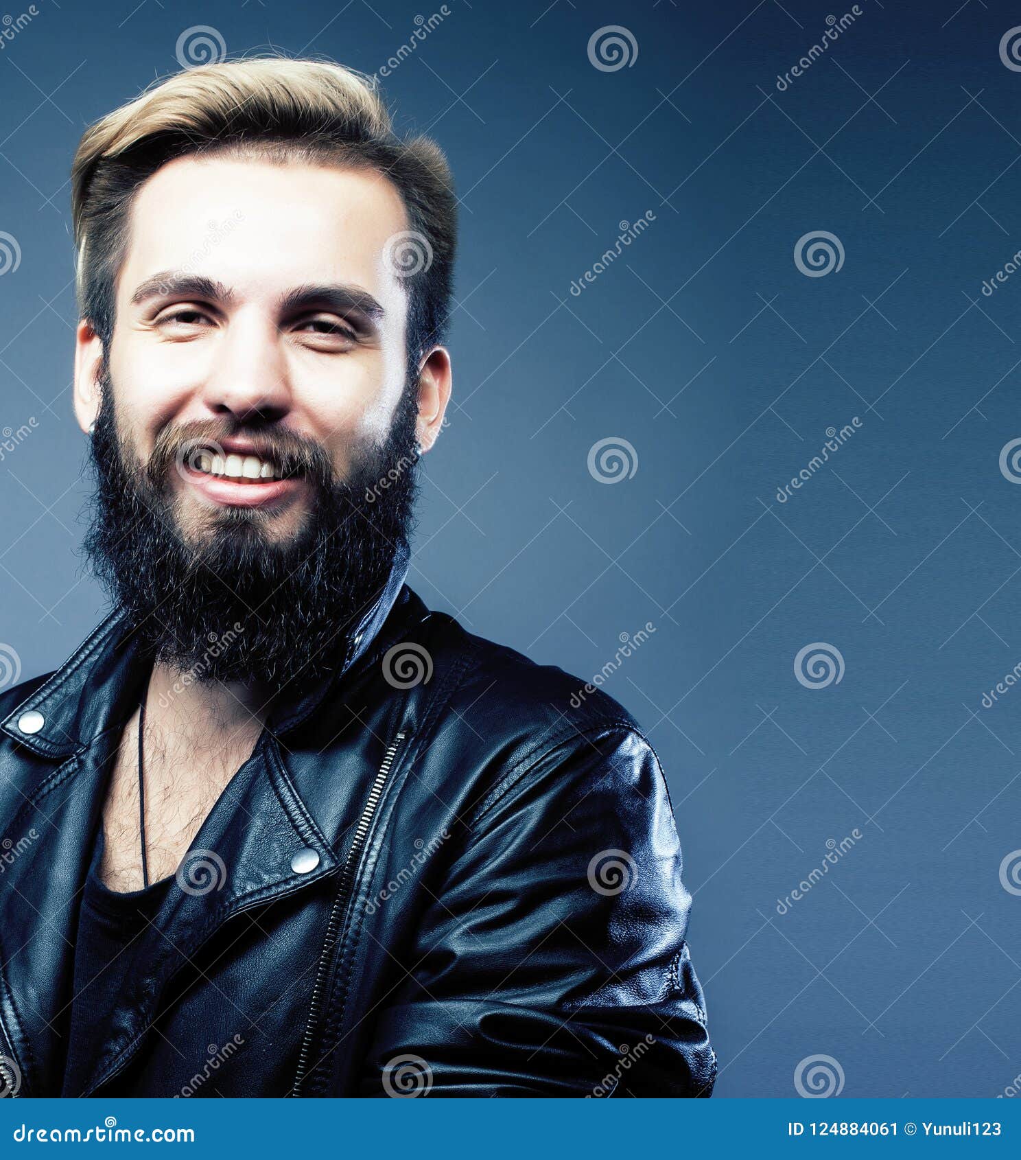 Portrait Of Young Bearded Hipster Guy Smiling On Gray Background Stock