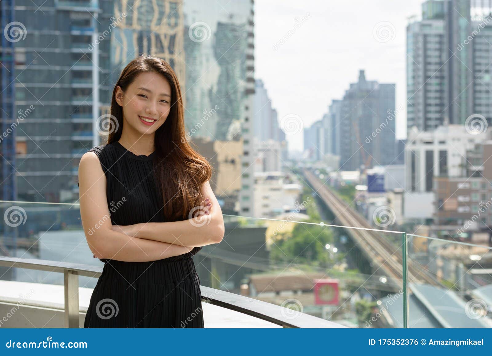 Happy Young Beautiful Asian Businesswoman Smiling with Arms Crossed ... Happy Young Beautiful Asian Businesswoman Smiling with Arms Crossed ...