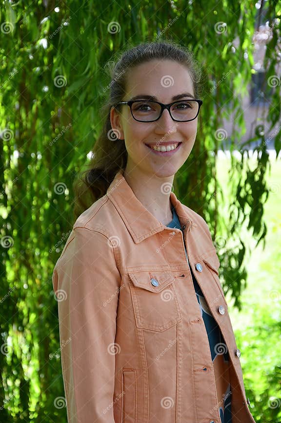 Friendly Smiling Young Woman With Long Blond Hair Outside In Nature