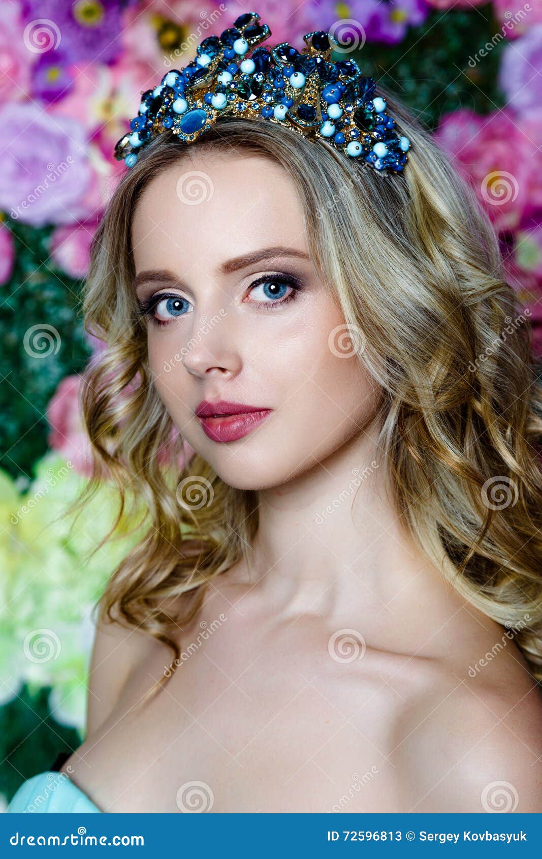 Portrait Of Young Beautiful Woman With Long Blond Hair In Elegant Blue