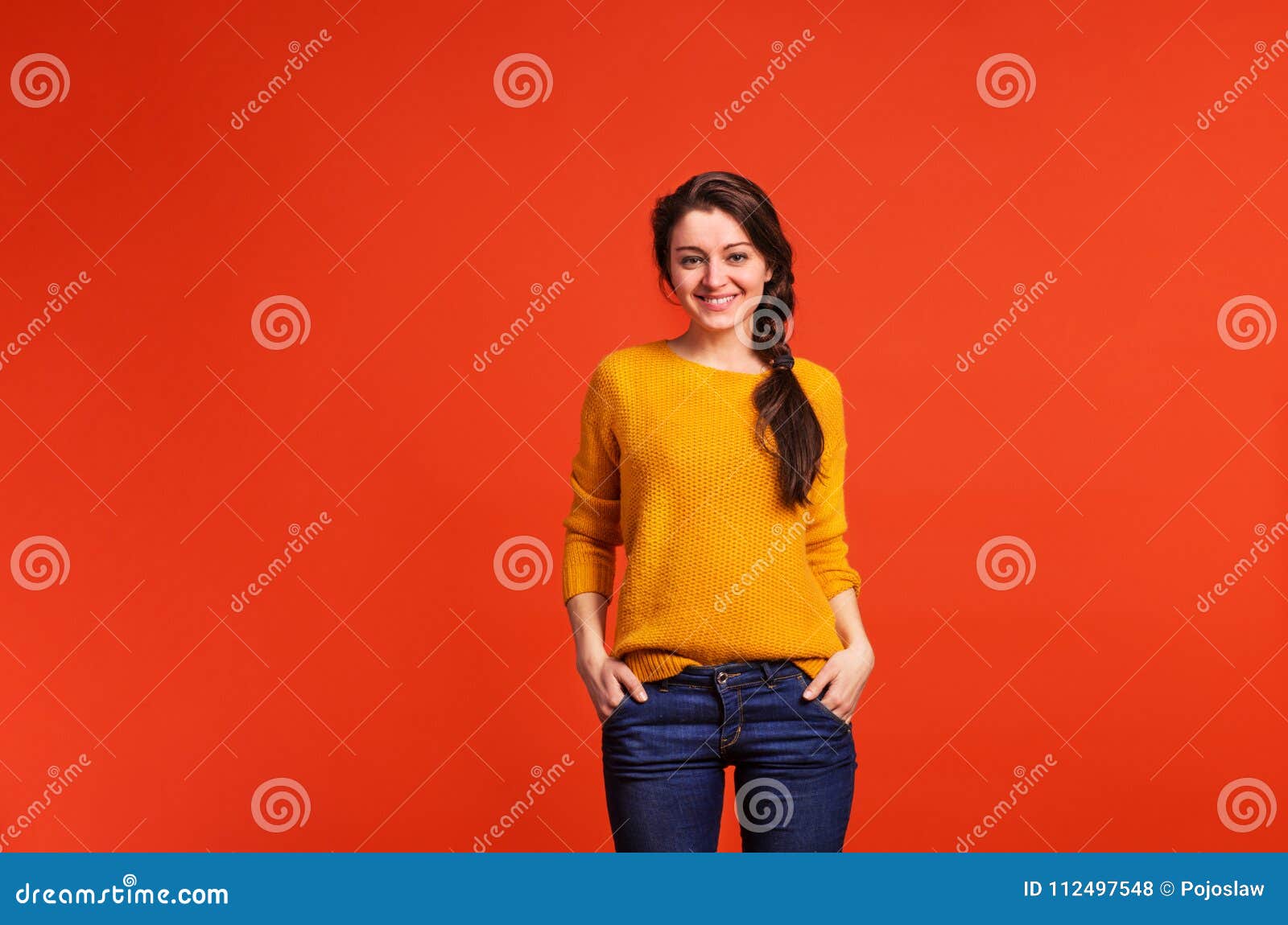 Portrait of a Young Beautiful Woman in Studio on a Red Background ...