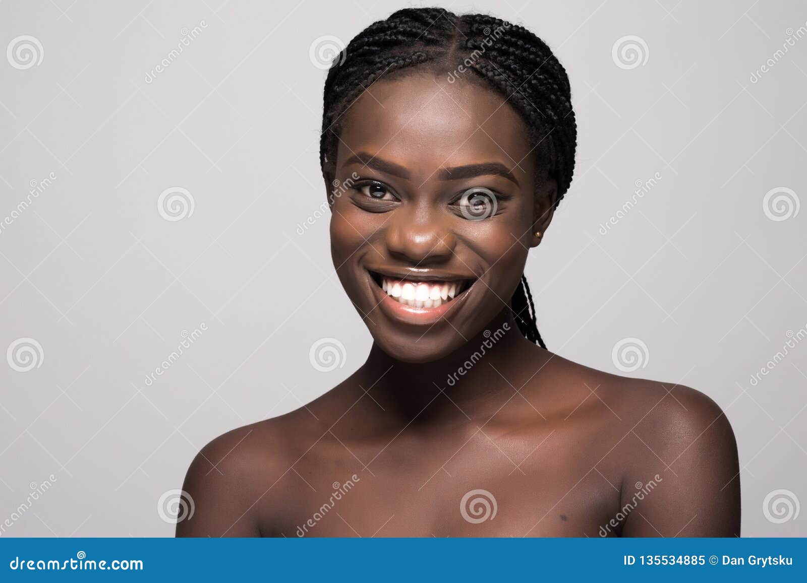 Portrait Of Young Beautiful African Woman Touching Her Face Isolated