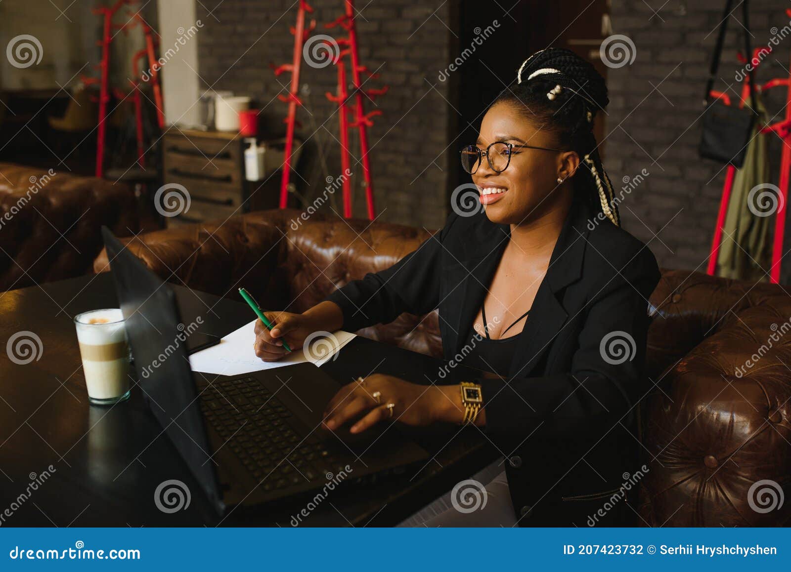 Portrait of a Young Black Woman Smiling and Using Laptop Stock Photo ...