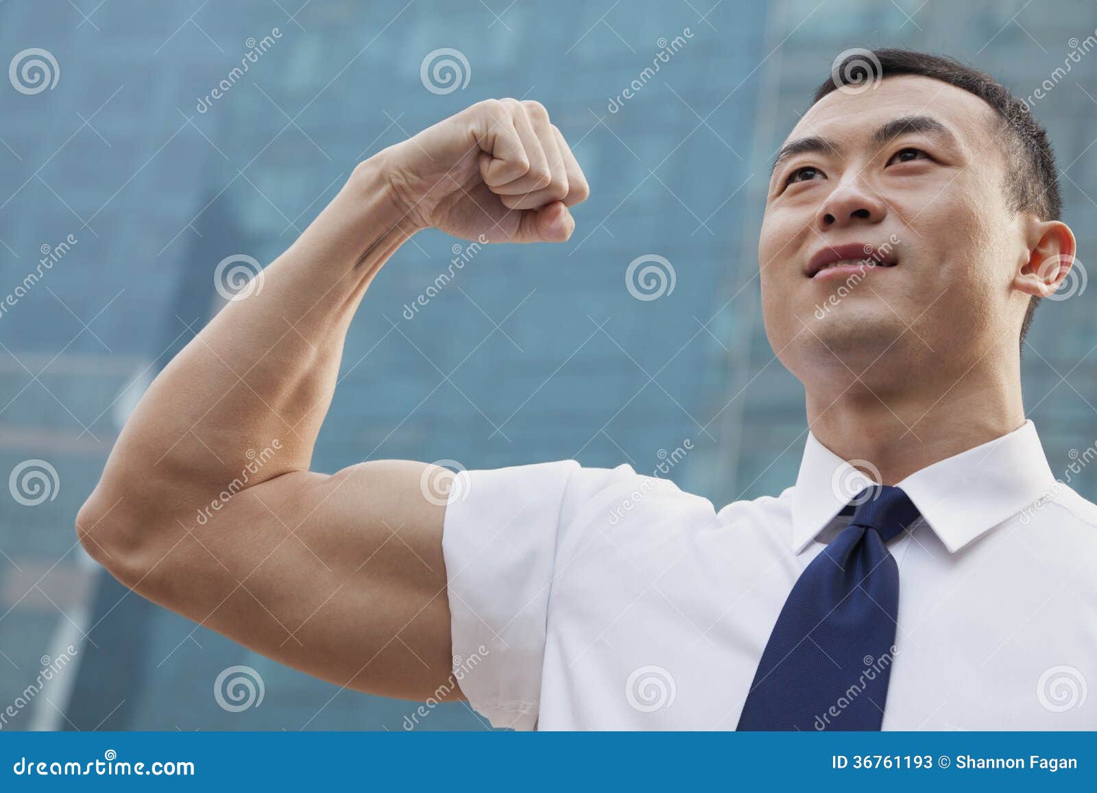 Portrait of Young Businessman Flexing Muscle Outdoors Stock Image ...