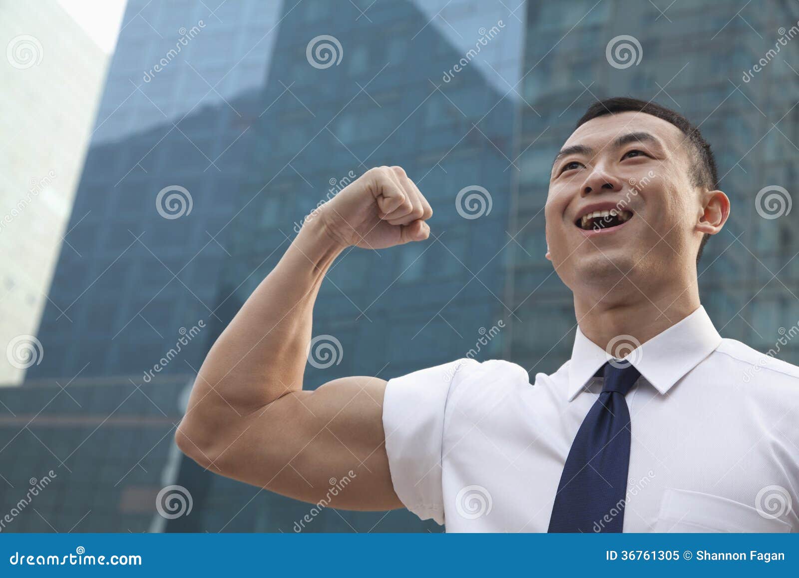 Portrait of Young Businessman Flexing Muscle Outdoors Stock Image ...