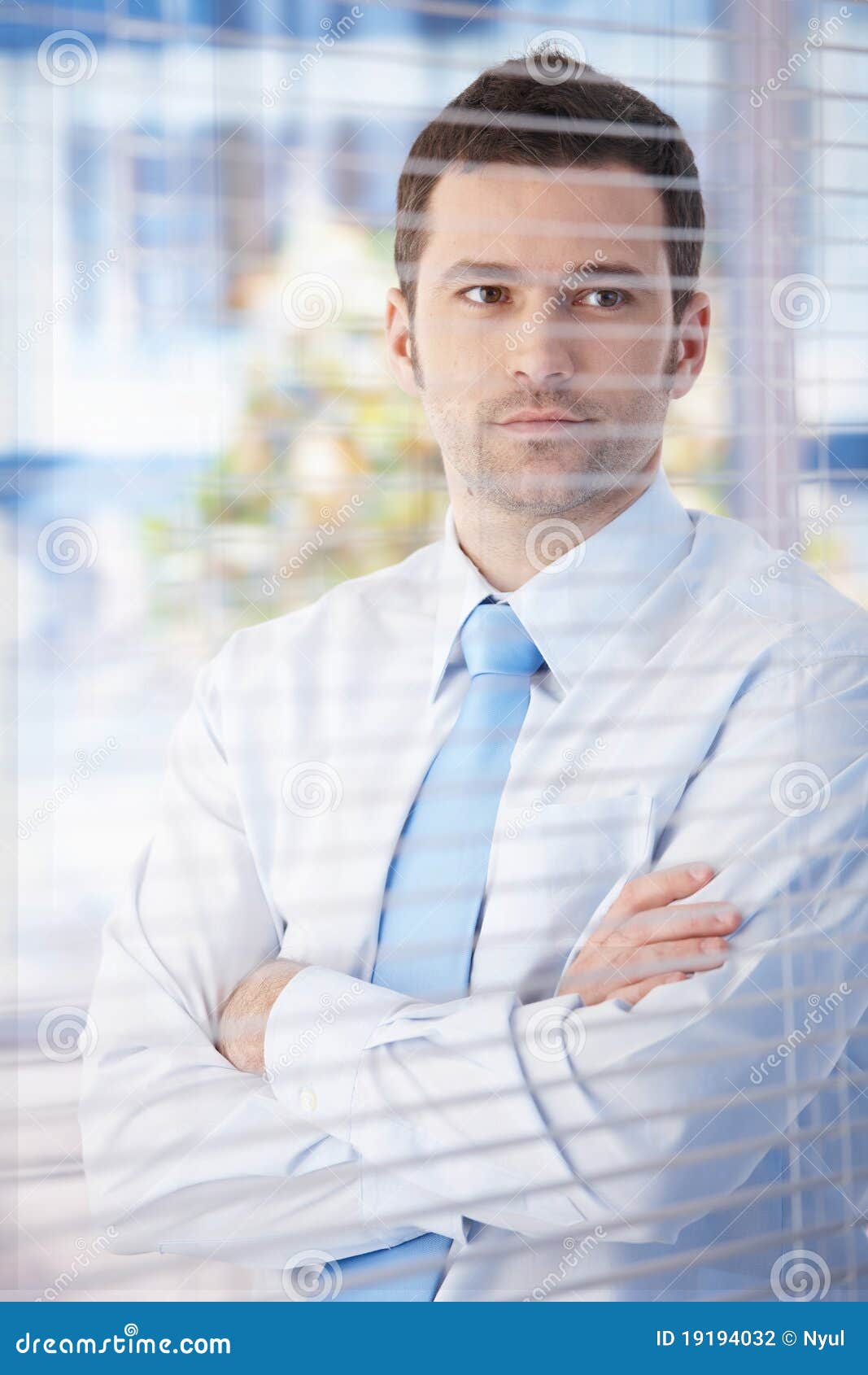 Portrait of Young Businessman in Office Stock Photo - Image of arms ...