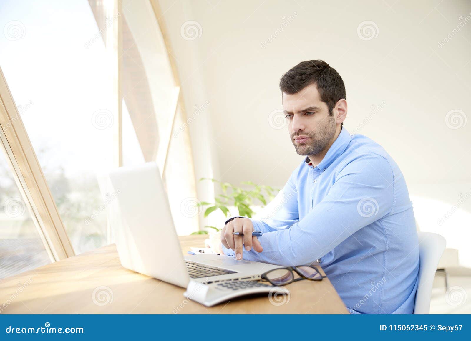 Young Businessman Working on Laptop Stock Image - Image of person ... Young Businessman Working on Laptop Stock Image - Image of person ...