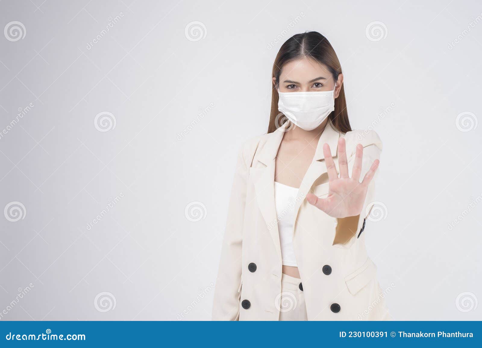 Portrait Of Young Businesswoman Wearing A Surgical Mask Over White