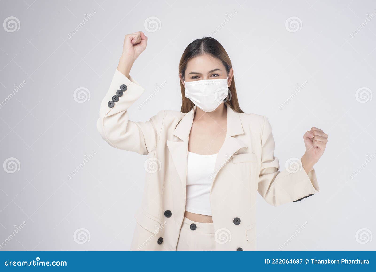 Portrait Of Young Businesswoman Wearing A Surgical Mask Over White
