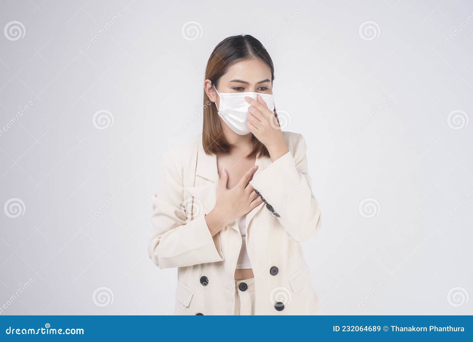 Portrait Of Young Businesswoman Wearing A Surgical Mask Over White