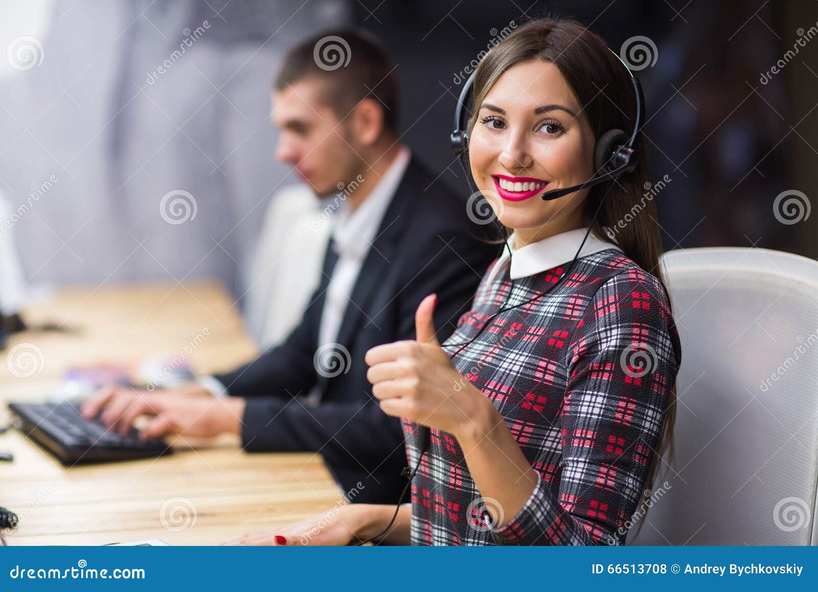 Portrait of Young Call Center Operator Wearing Headset with Colleagues ...