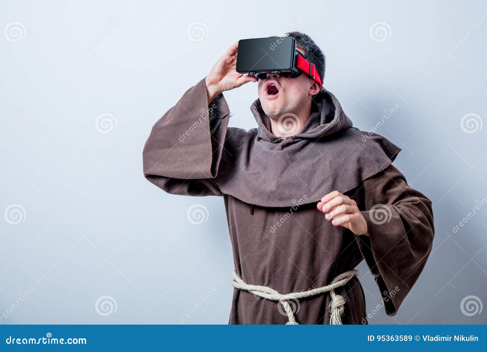 A Young Catholic Priest Holds A Rosary In His Hand In Prayer. The ...