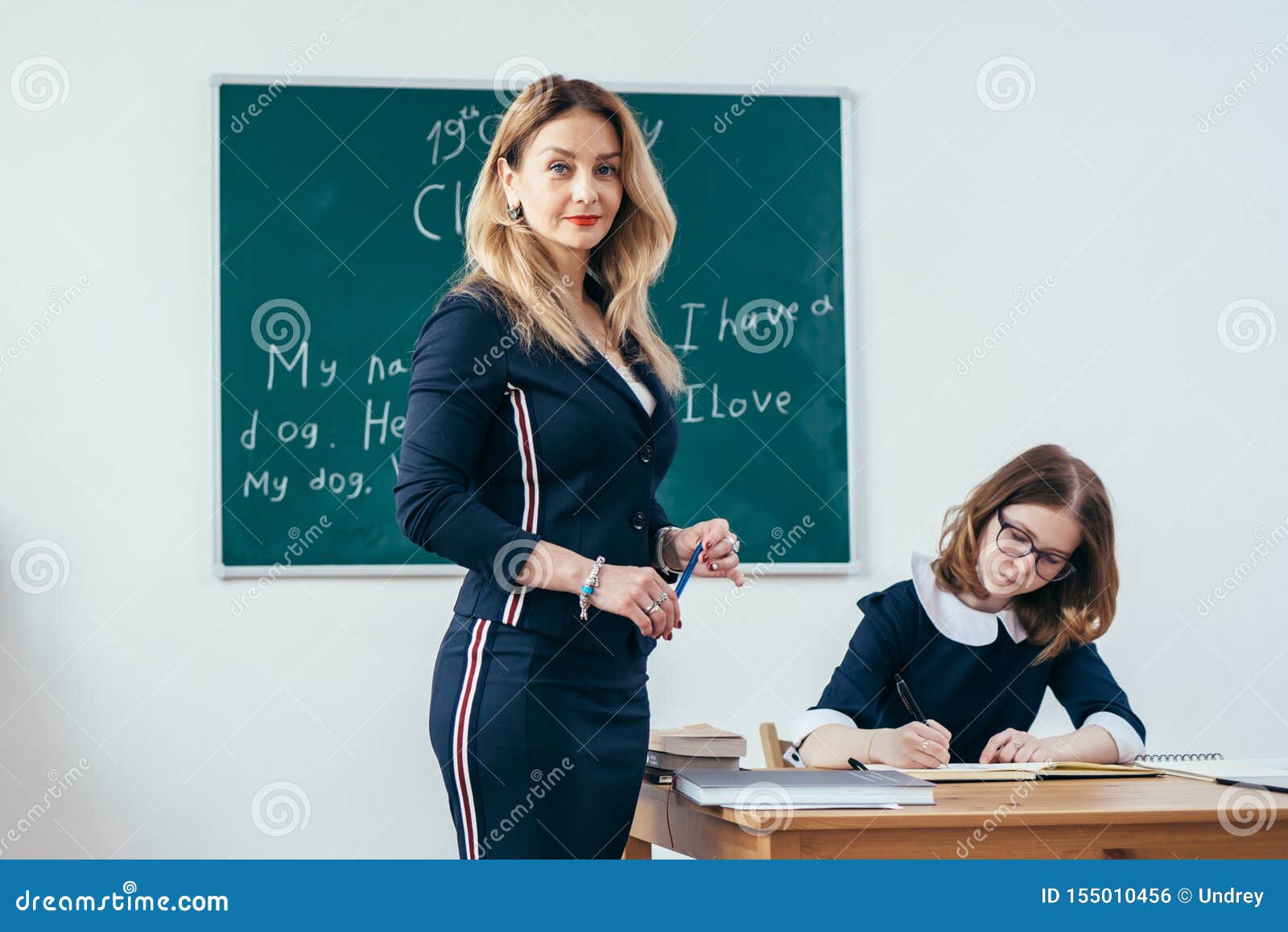 Portrait Of Young Caucasian Female Teacher In School Classroom Stock