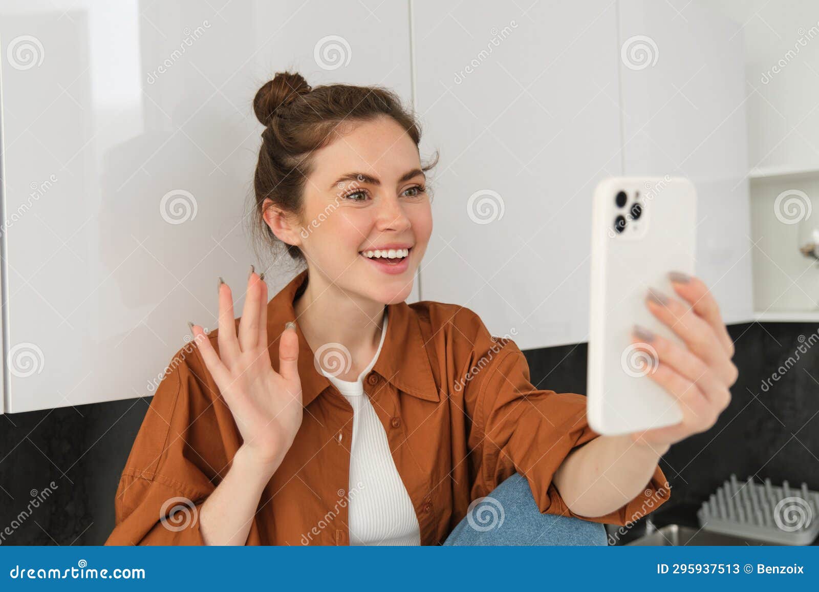 Portrait Of Young Cheerful Woman Laughing And Smiling During Phone Call