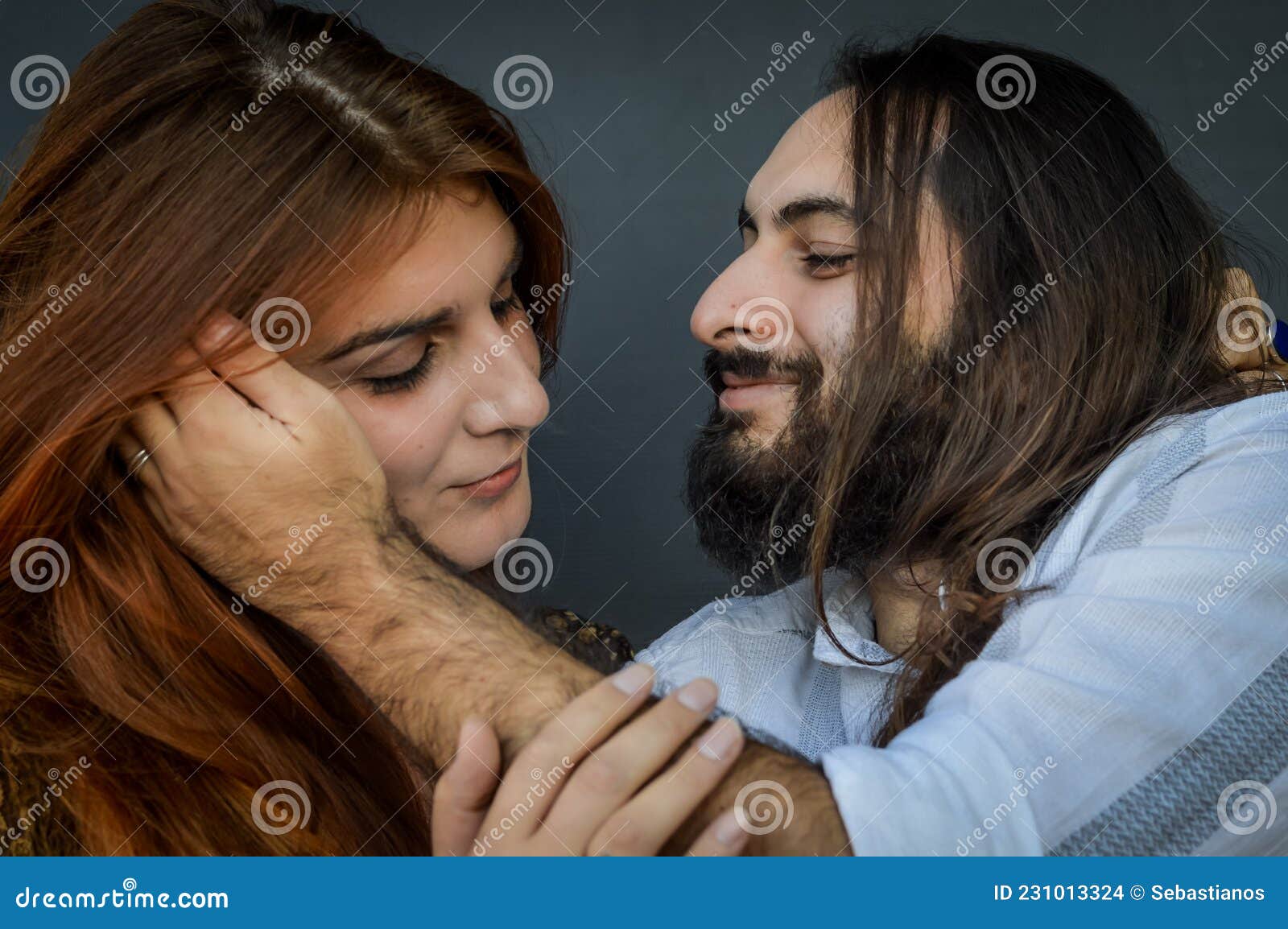 Portrait Of A Young Couple Where The Young Man With Beard And Long Hair