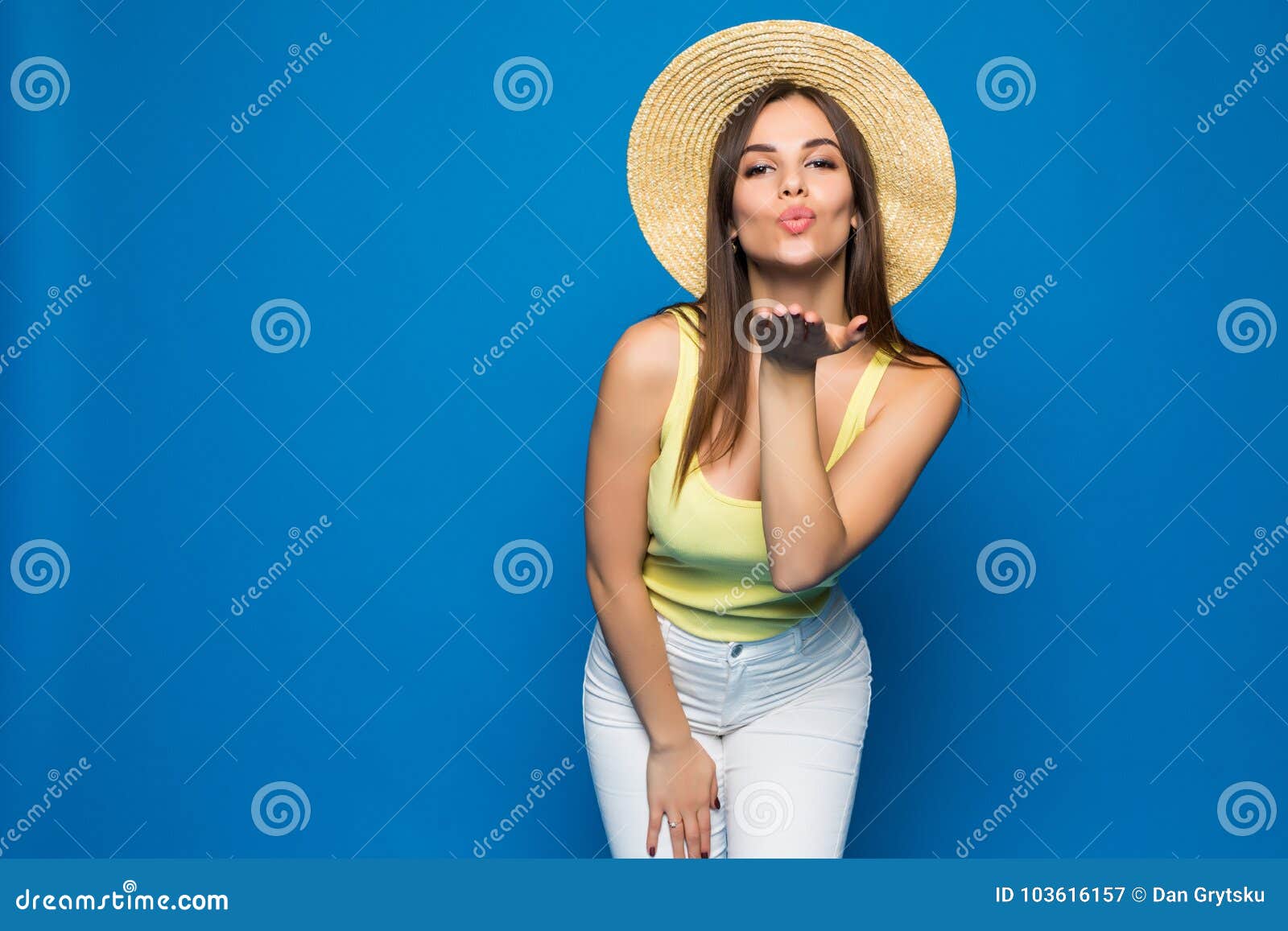 Portrait Of A Young Cute Woman Blowing Kiss At Camera Isolated On The